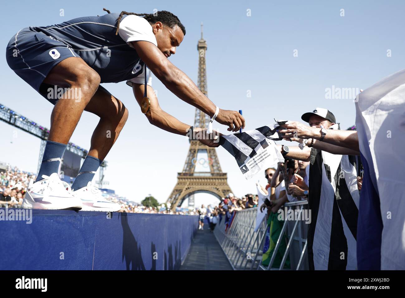 A French rugby sevens player signs an autograph at the Paris Olympics ...