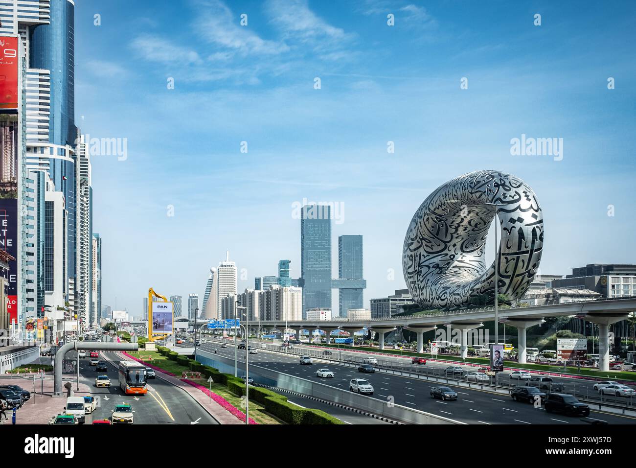 Sheikh Zayed road traffic with skyscrapers and Museum of the future. Line of Dubai Metro UAE ...