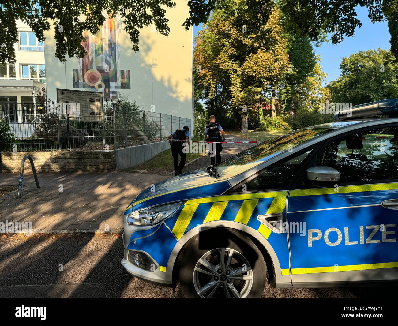 Magdeburg, Germany. 20th Aug, 2024. Police officers stand in front of ...