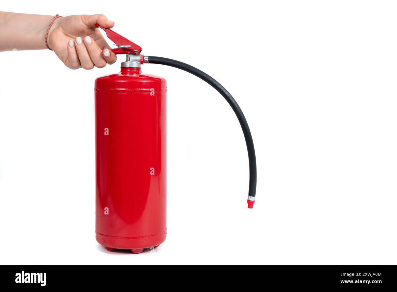 A red cylinder fire extinguisher with a black hose, contrasting on a ...