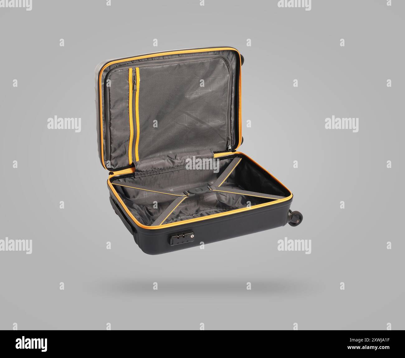 Open empty suitcase in air on light grey background Stock Photo - Alamy