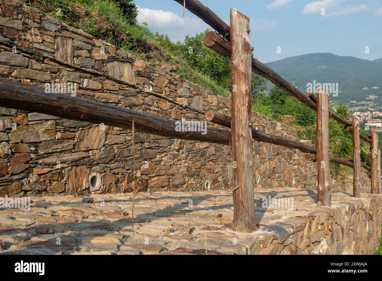 handrail for mountain path, detail of wooden fence with poles with ...