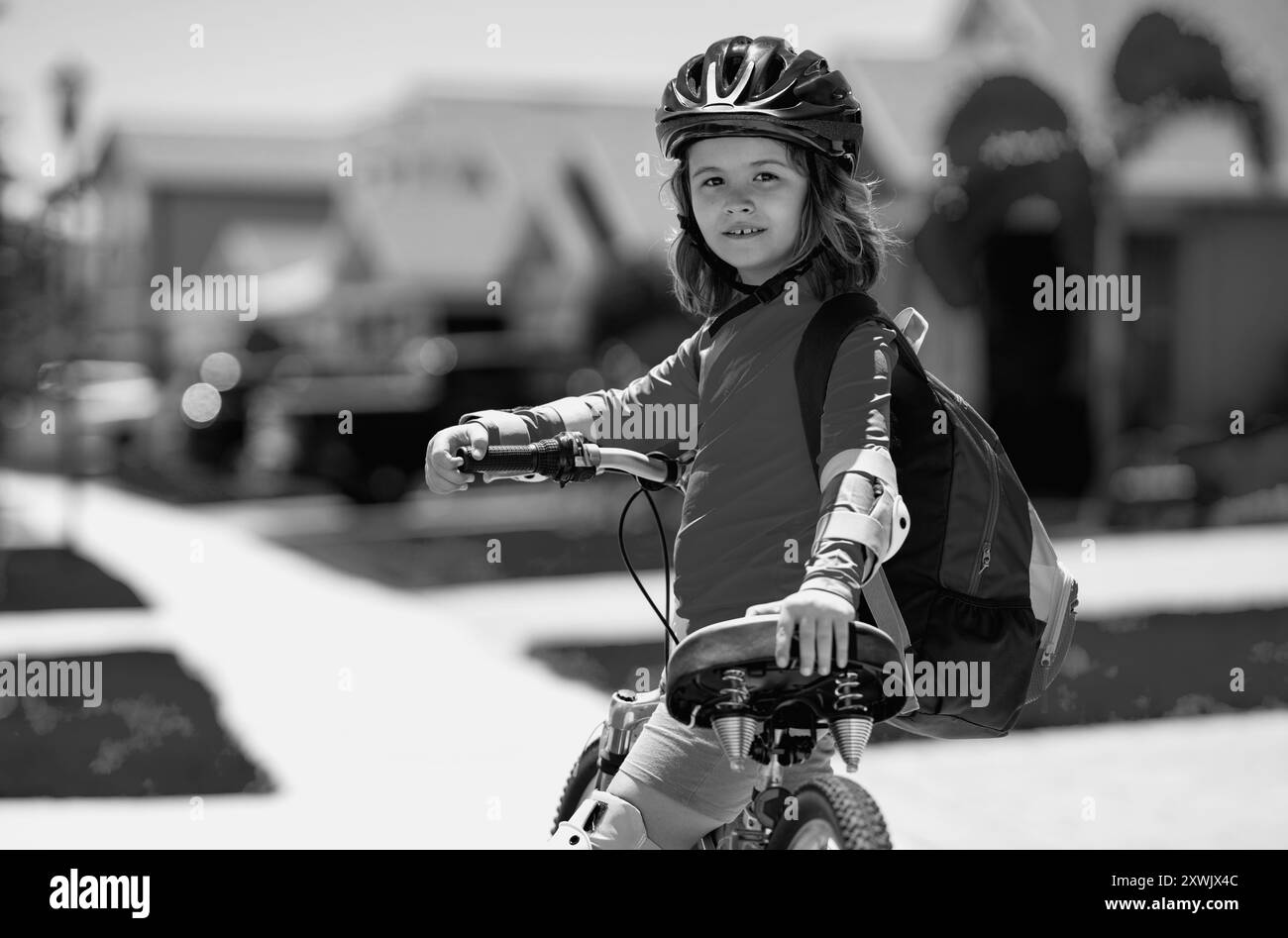 Little kid boy riding a bike in summer park. Child drive a bike on a ...