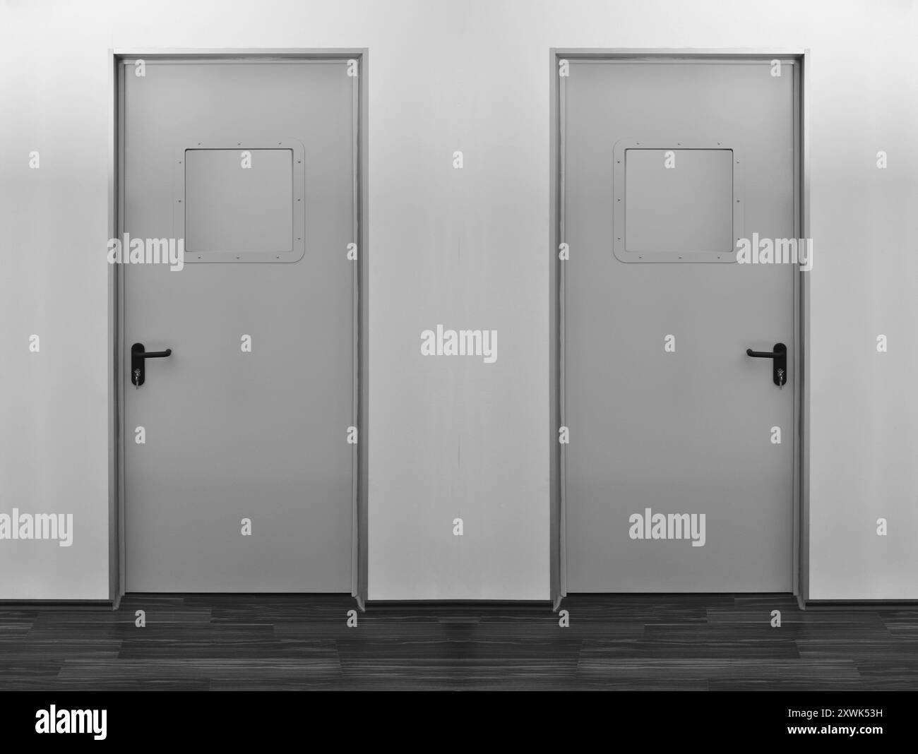 Emergency exit two grey door. Closed up latch and orange door handle of ...