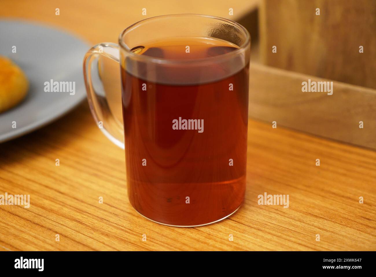 Black Turkish tea in a delicate pine cup stands on the wooden table ...