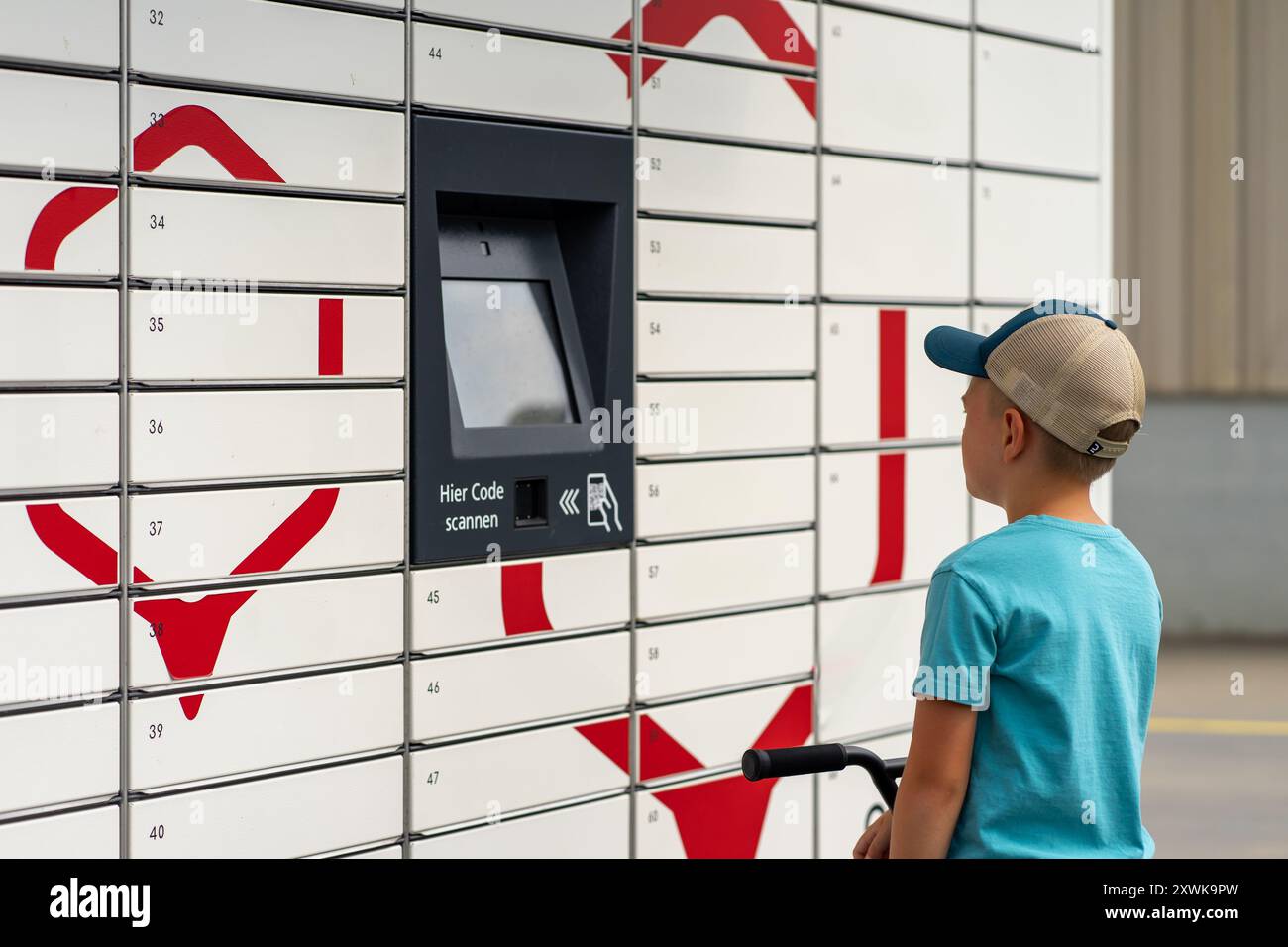 A boy receives a parcel in one of the parcel lockers Stock Photo - Alamy
