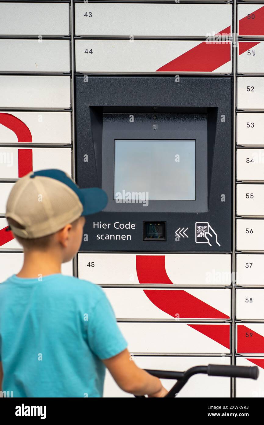 A boy receives a parcel in one of the parcel lockers Stock Photo - Alamy