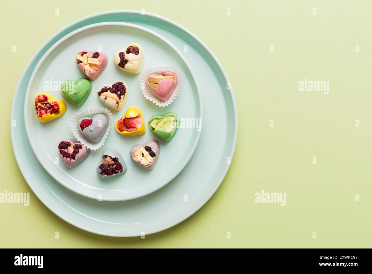 Plate with different chocolate on colored background. Assortment of ...