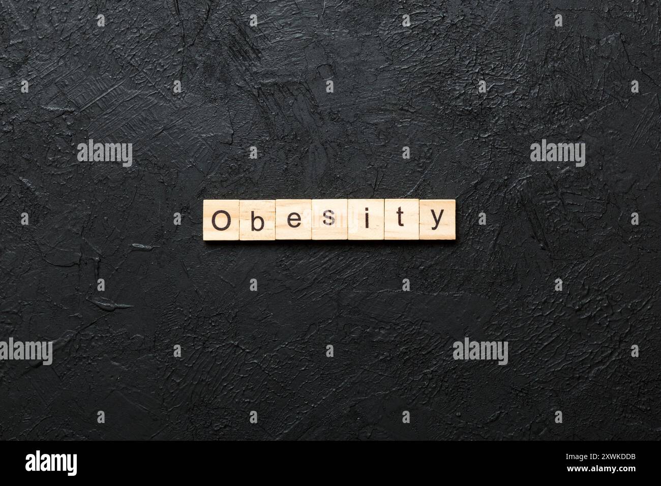 Obesity word written on wood block. Obesity text on cement table for ...