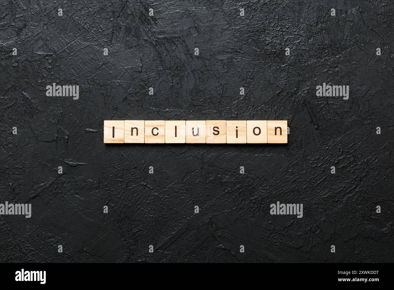 Inclusion word written on wood block. Inclusion text on cement table ...