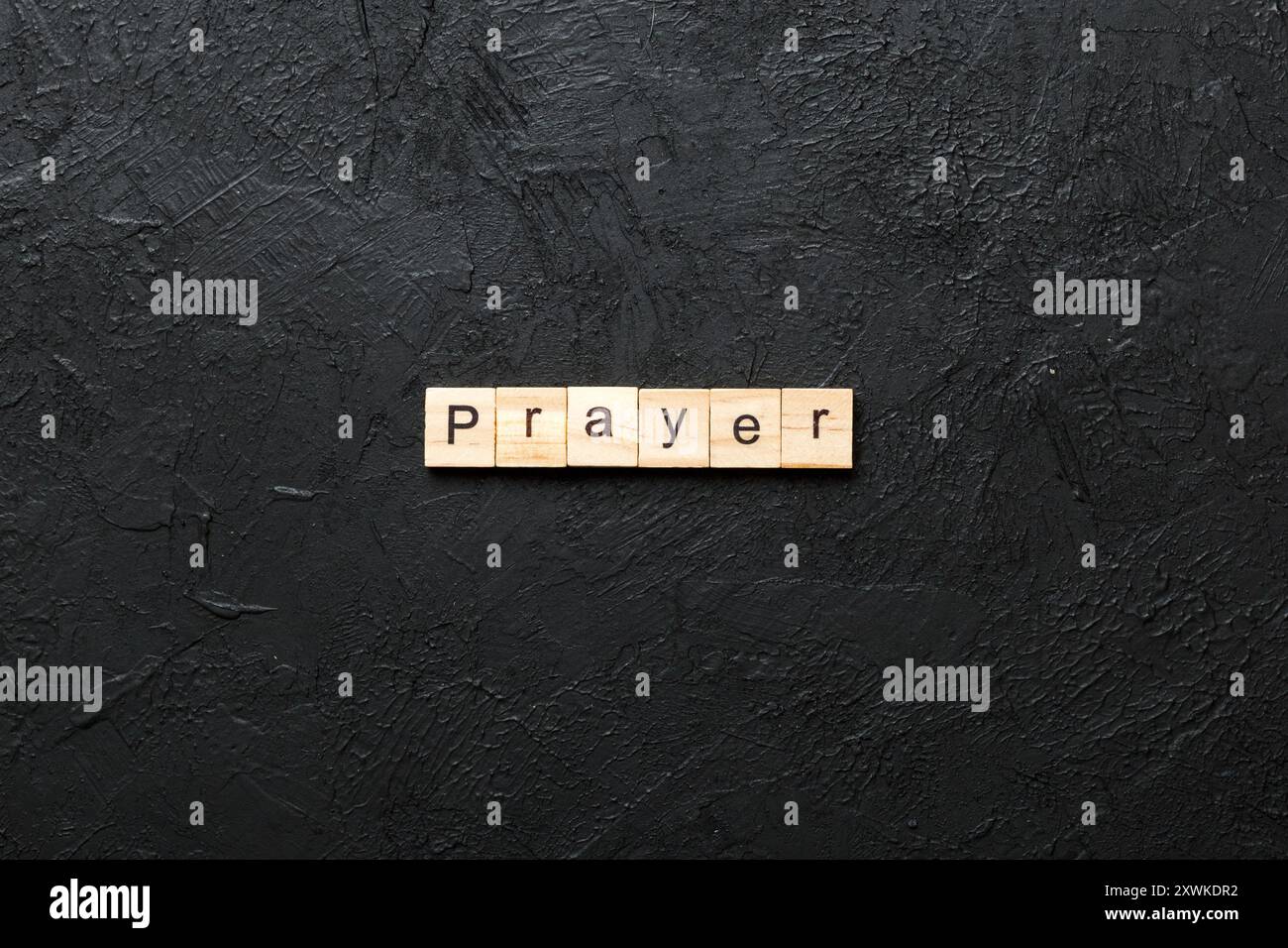 PRAYER word written on wood block. PRAYER text on cement table for your ...