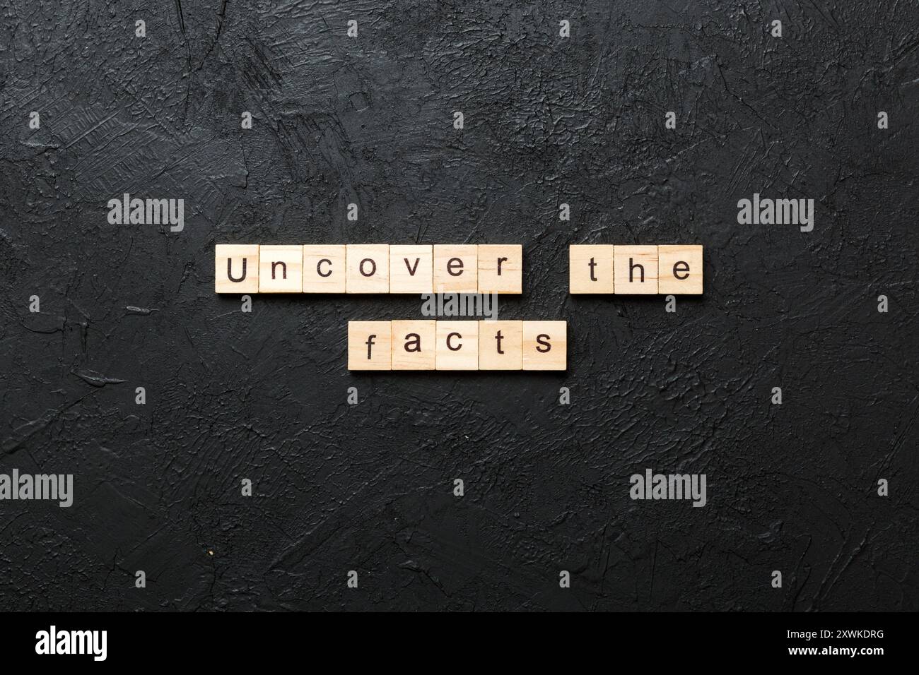 uncover the fact word written on wood block. uncover the fact text on ...
