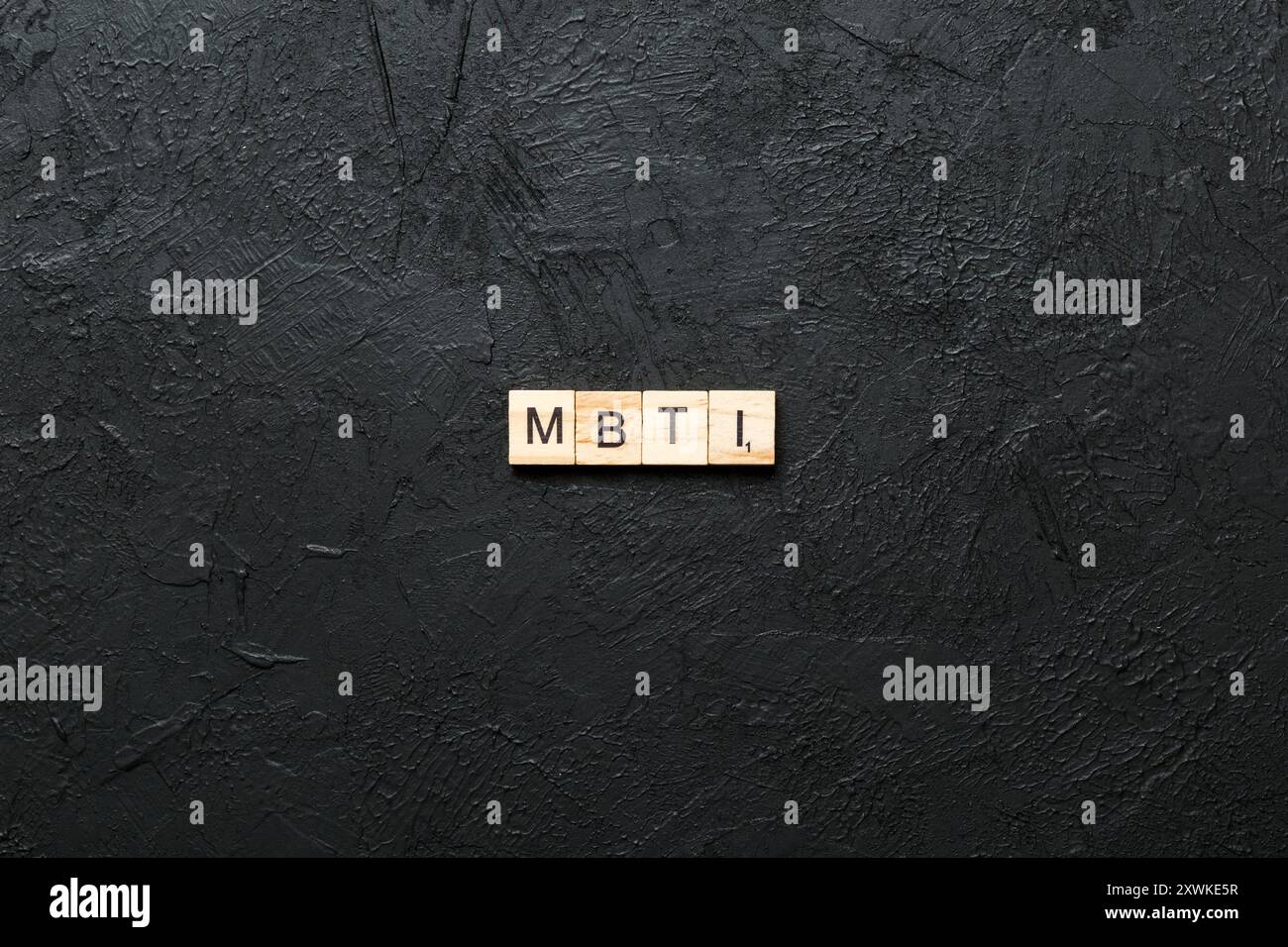 MBTI word written on wood block. Myers-Briggs Type Indicator text on ...