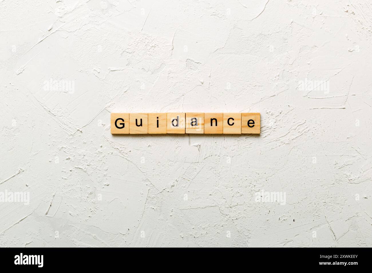 Guidance word written on wood block. Guidance text on table, concept ...