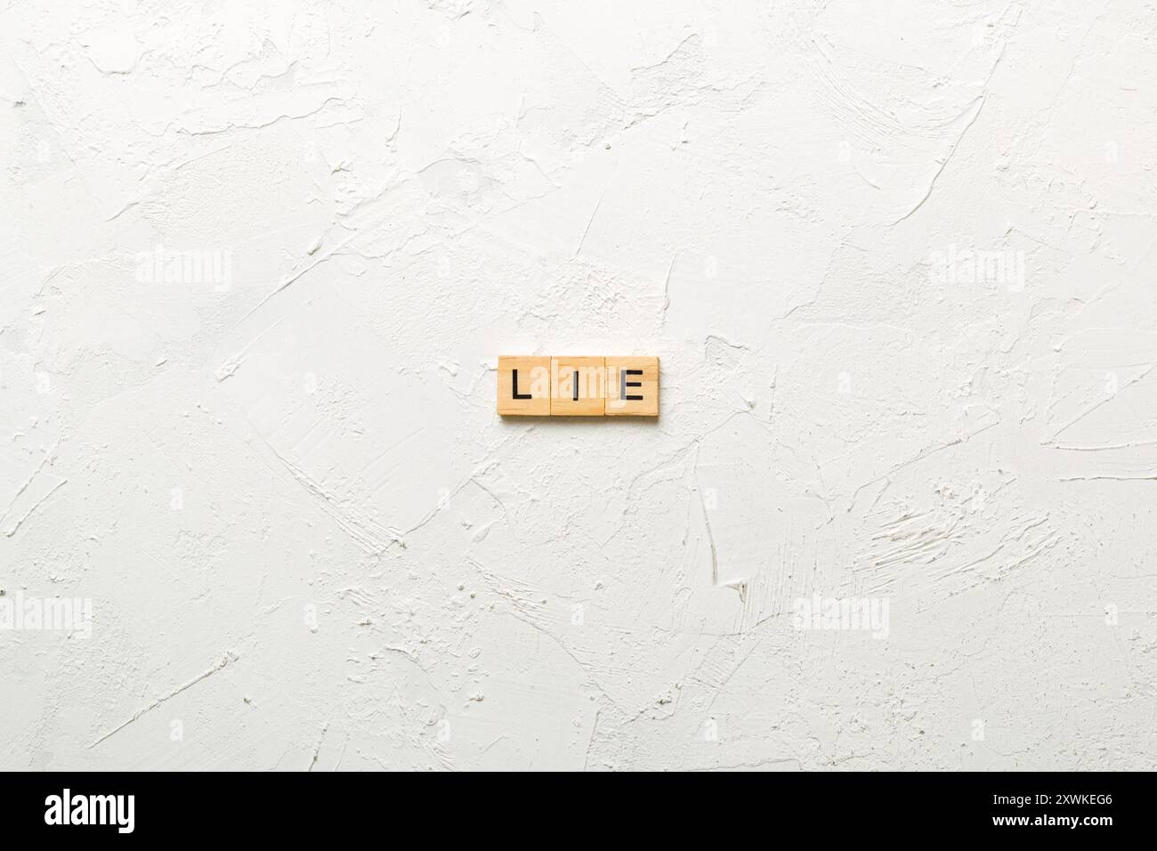 LIE word written on wood block. LIE text on cement table for your desing, concept Stock Photo ...