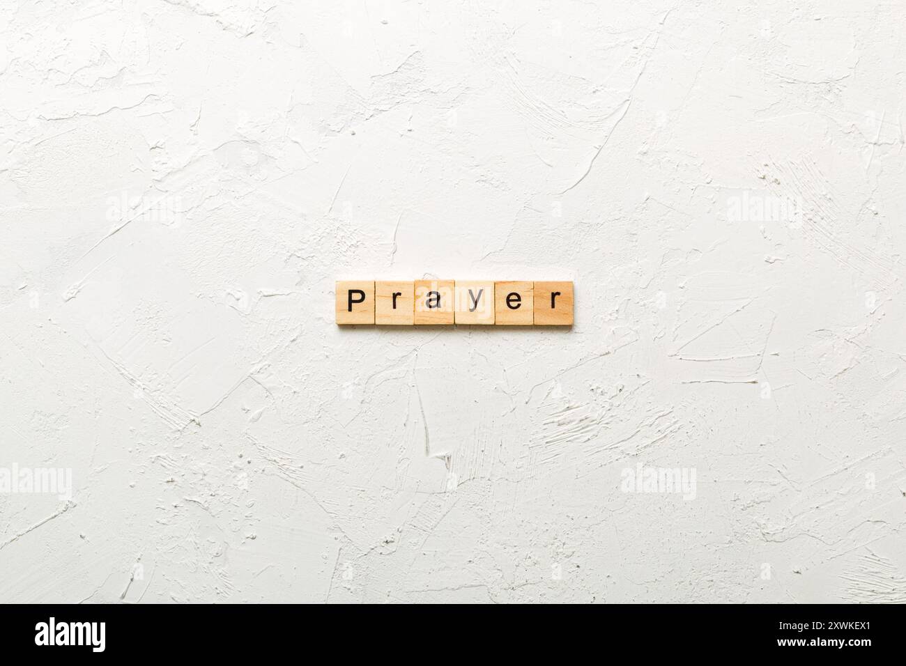 PRAYER word written on wood block. PRAYER text on cement table for your ...