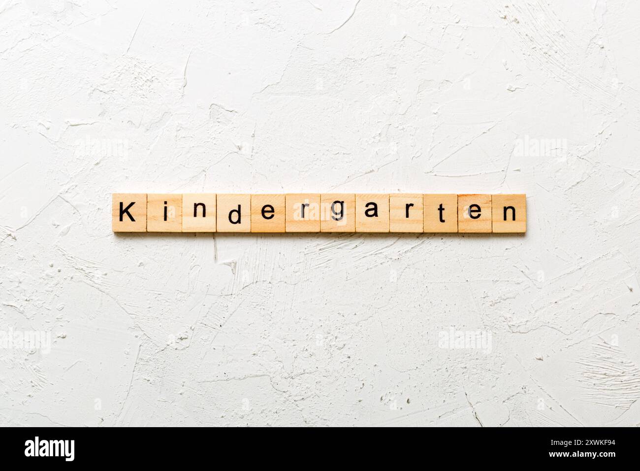 kindergarten word written on wood block. kindergarten text on table ...