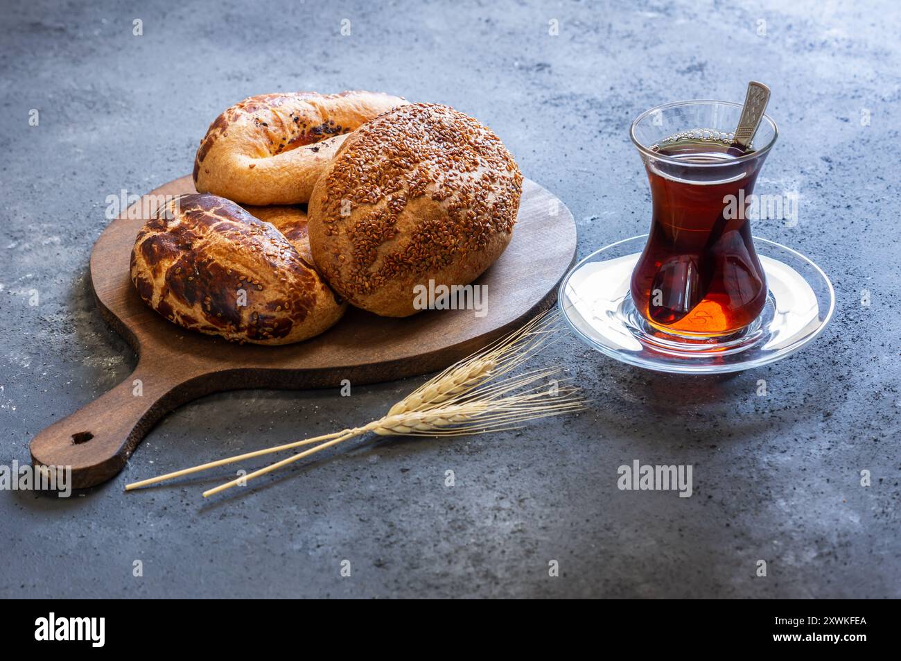 Traditional Turkish pastries pogaca with cheese on cutting board ...