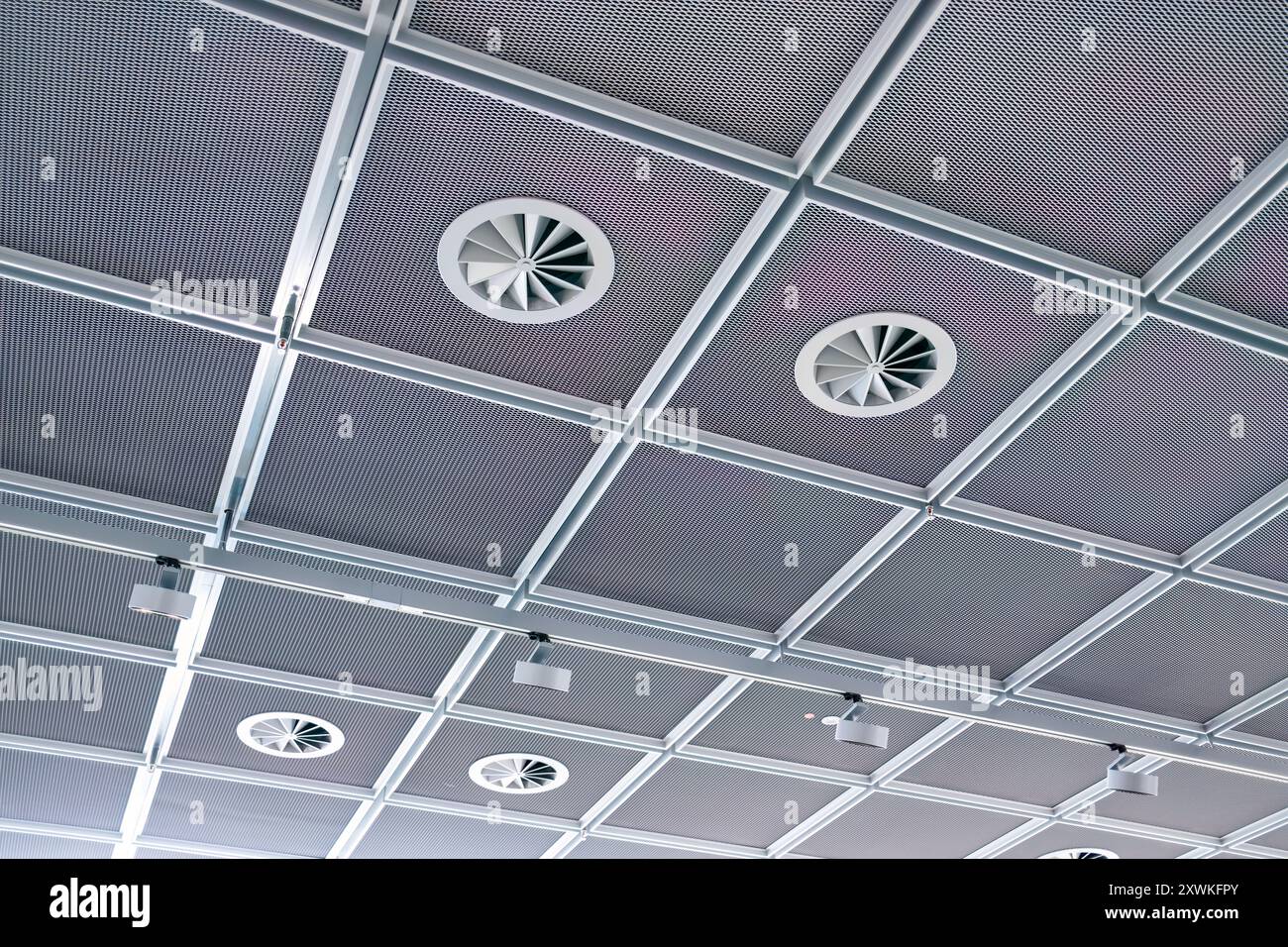 Modern ceiling pattern of white tiles and ventilation pipes, lights ...