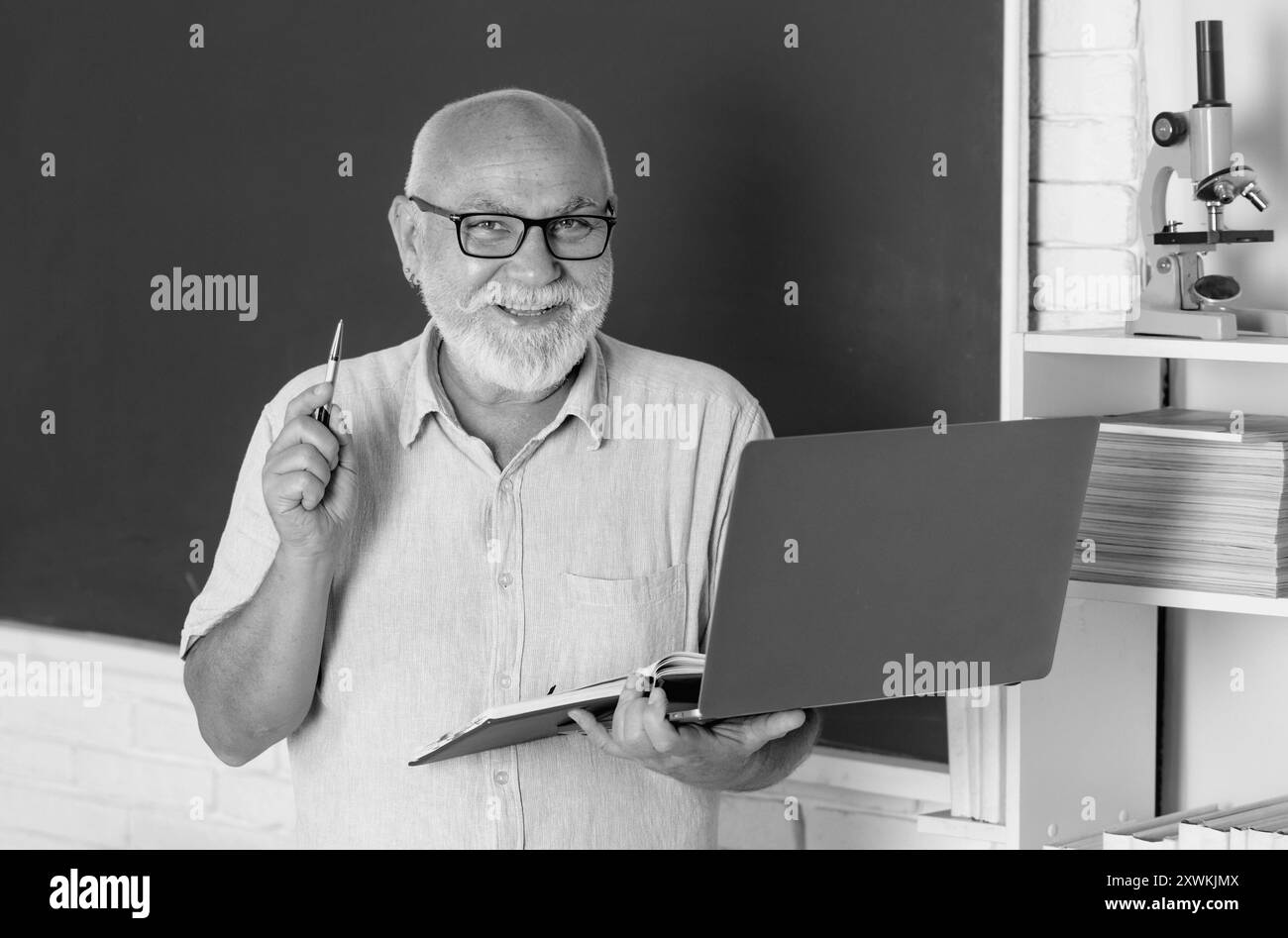 Senior teacher. Portrait of mature teacher in classroom. Back to school ...