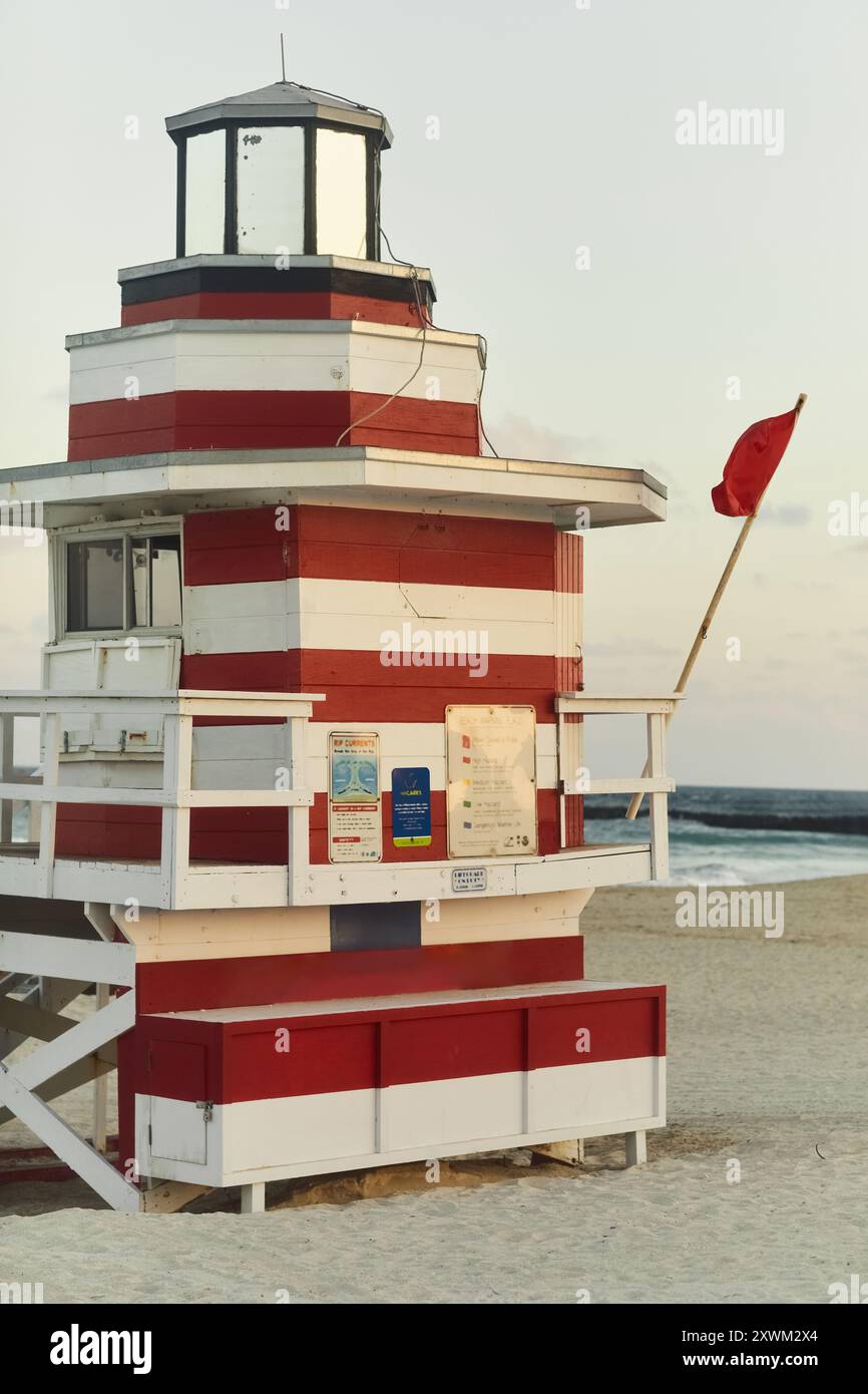 A classic Miami Beach lifeguard stand with a red flag flying, signaling ...