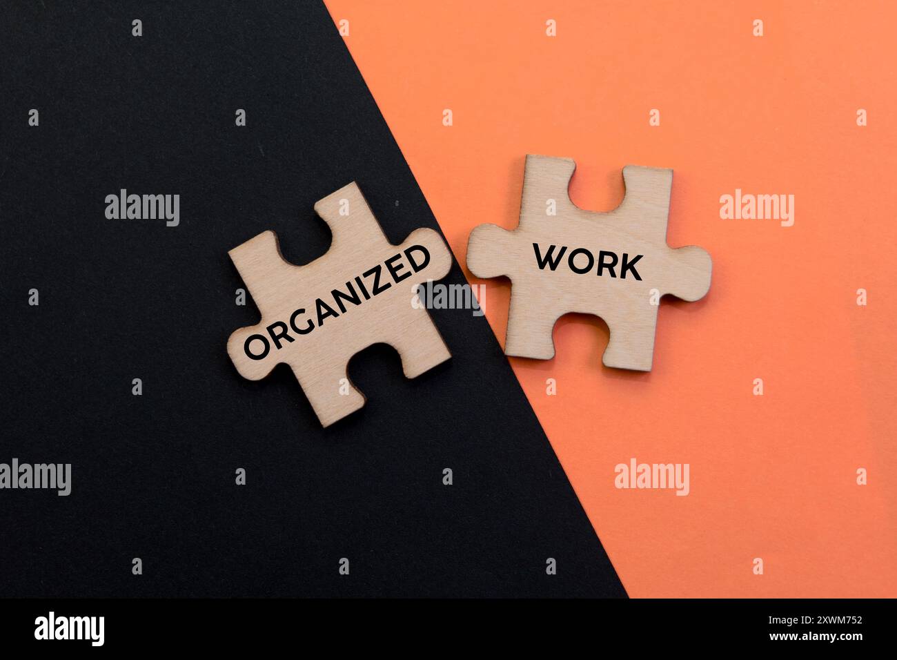 Two puzzle pieces labeled "Organized" and "Work" lay on a vibrant ...