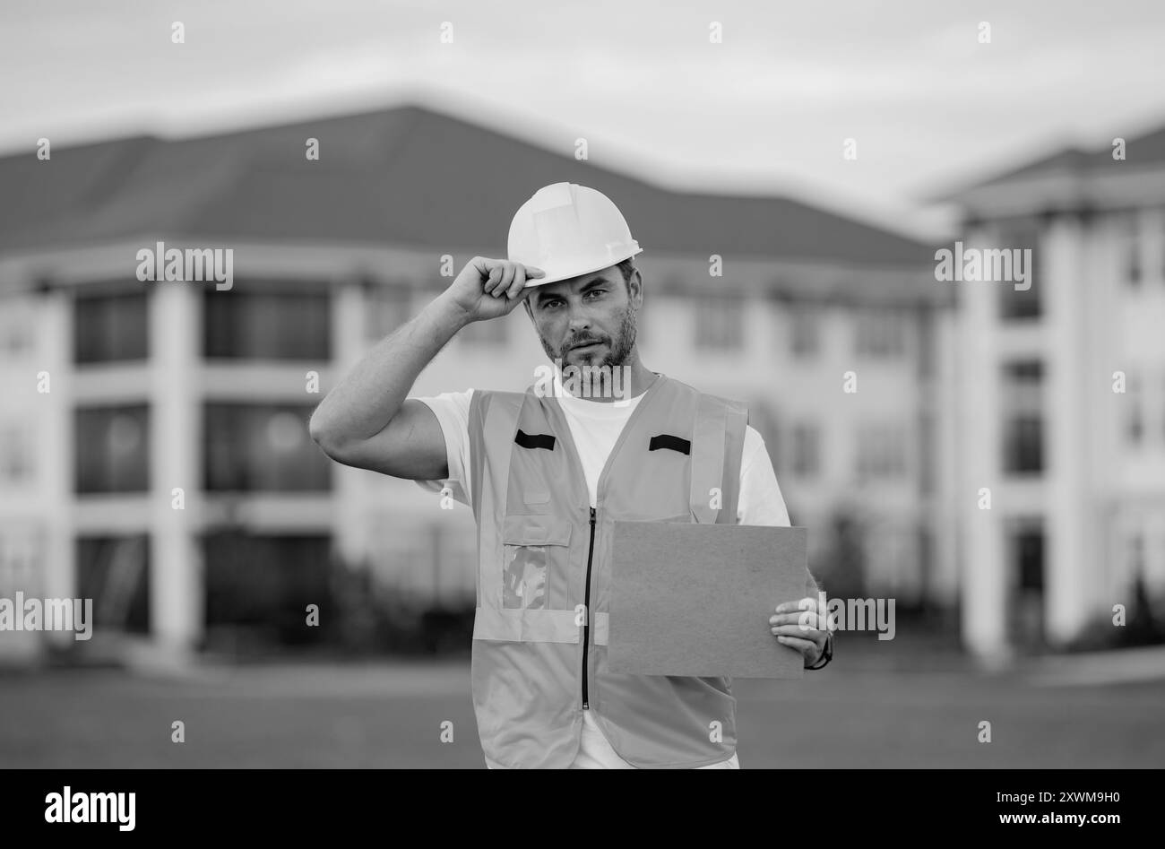 Engineer hold paper board for text. Builder showing signboard placard ...