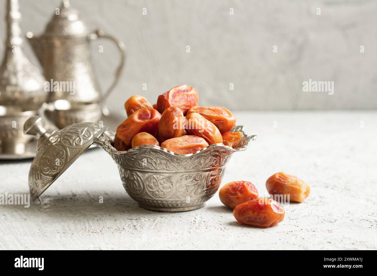 Ramadan palm fruit dates in silver bowl and zam zam water symbolize ...