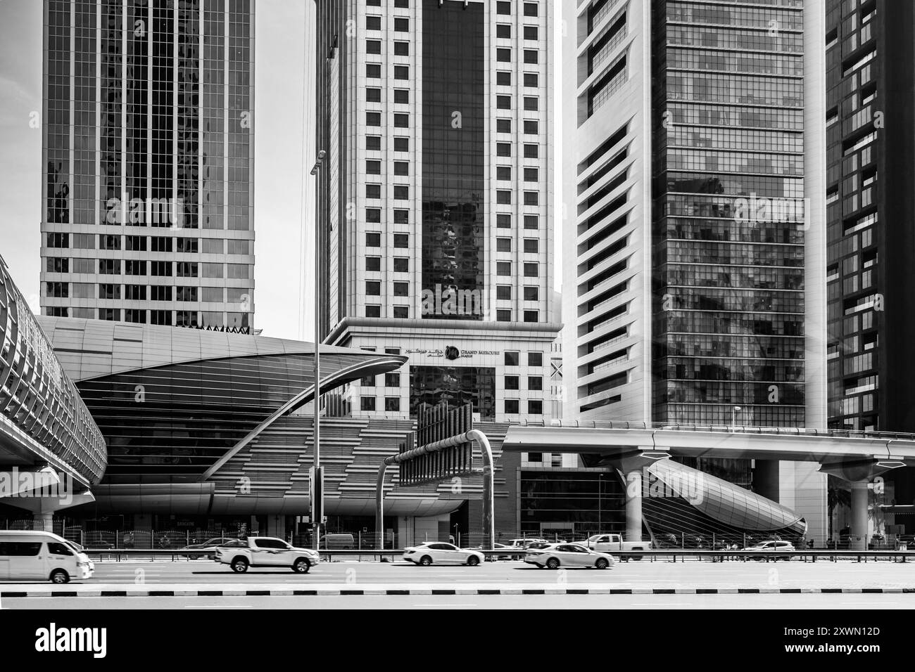Sheikh Zayed road traffic day with skyscrapers. Line of Dubai Metro UAE ...