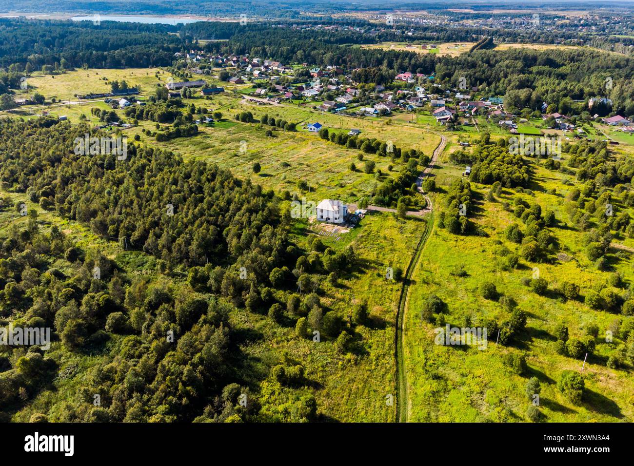 Aerial view of village outskirts in scenic flat area, suburban real ...
