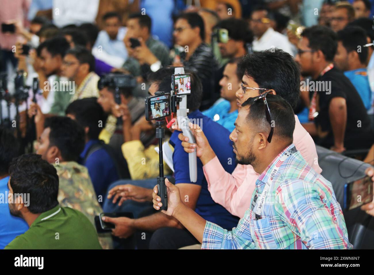 Bangladeshi people cover incidents using mobile devices on the streets in Dhaka, Bangladesh on ...