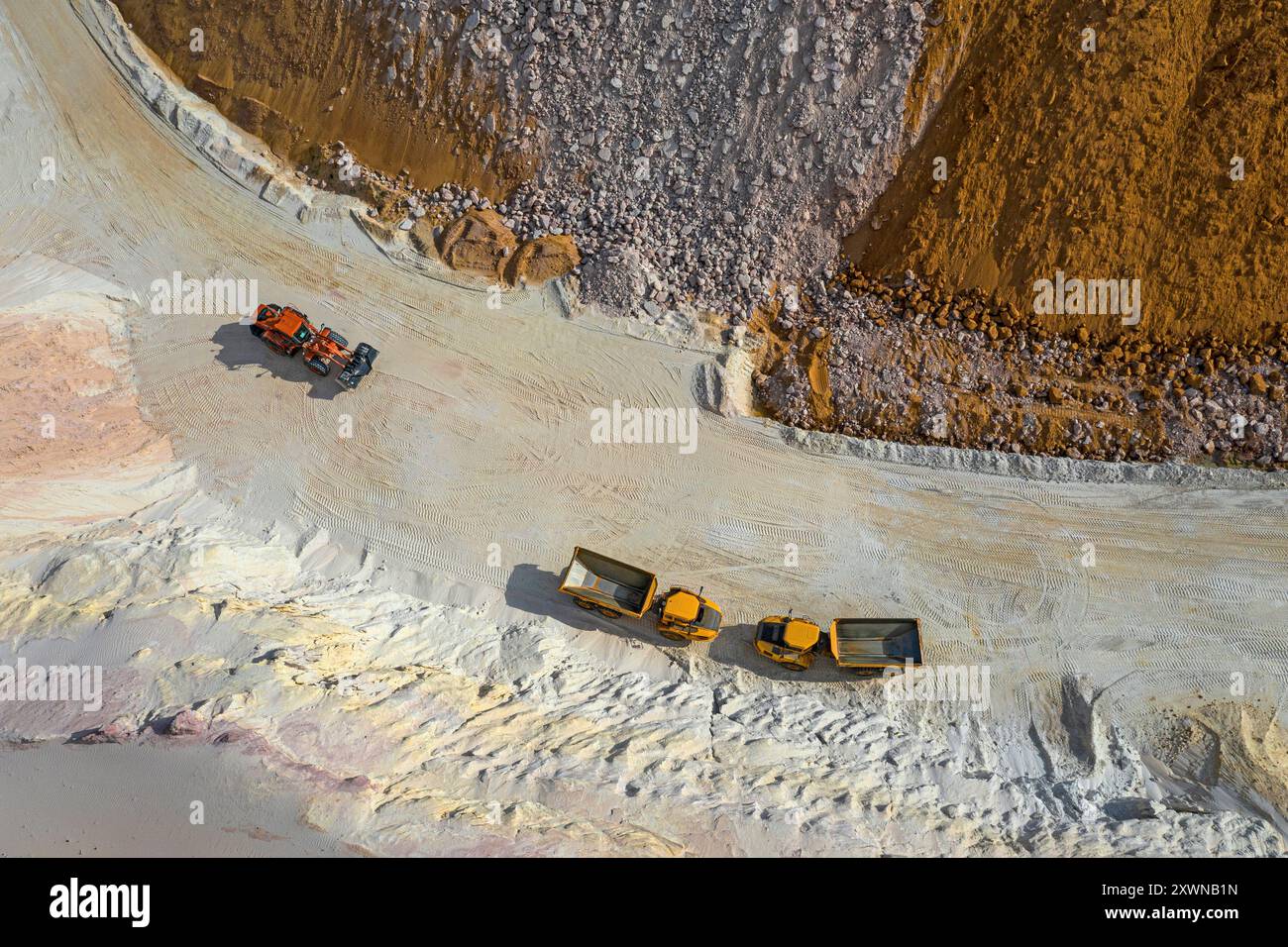 Aerial drone view of construction machinery, dumprer and hauler in a ...