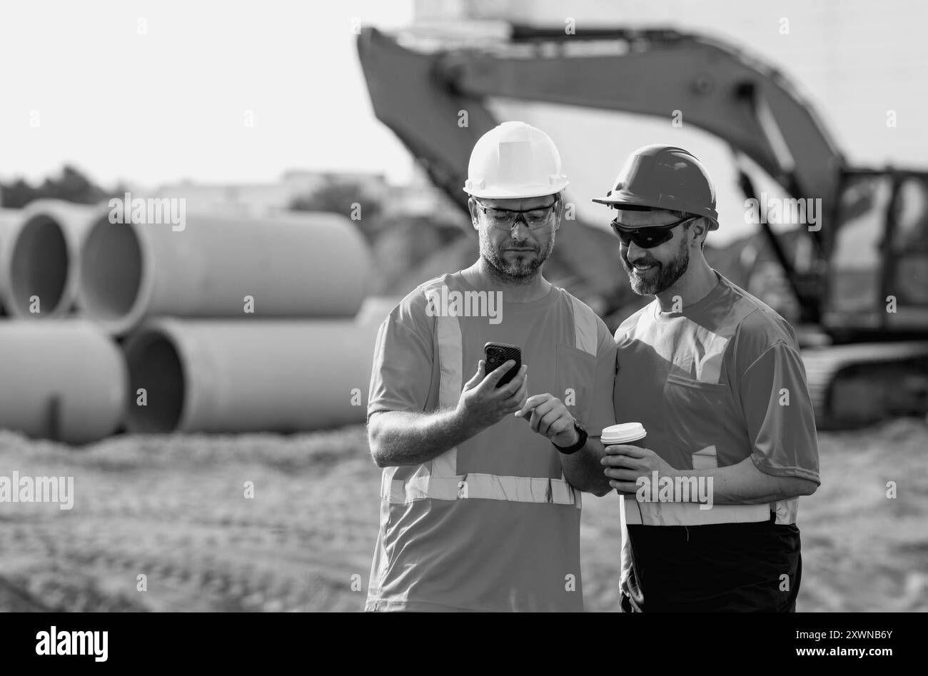 Builders on the job. Two builders in a hard hat at construction site ...