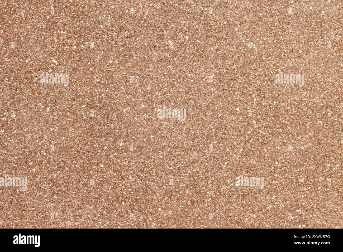 Close-up texture of brown rough wall surface with small stones and ...