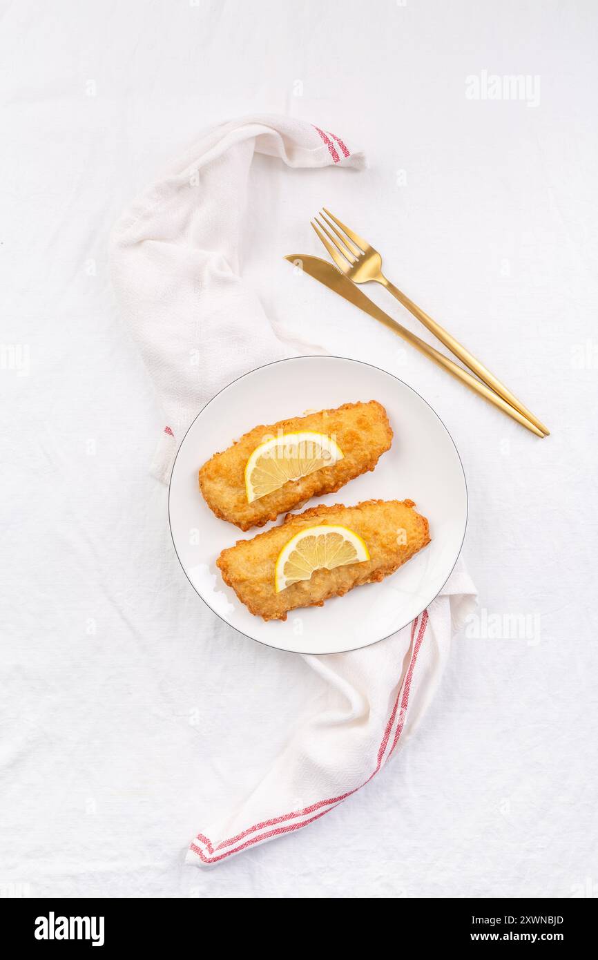 Crispy breaded fish with dipping sauce and lemon Stock Photo - Alamy
