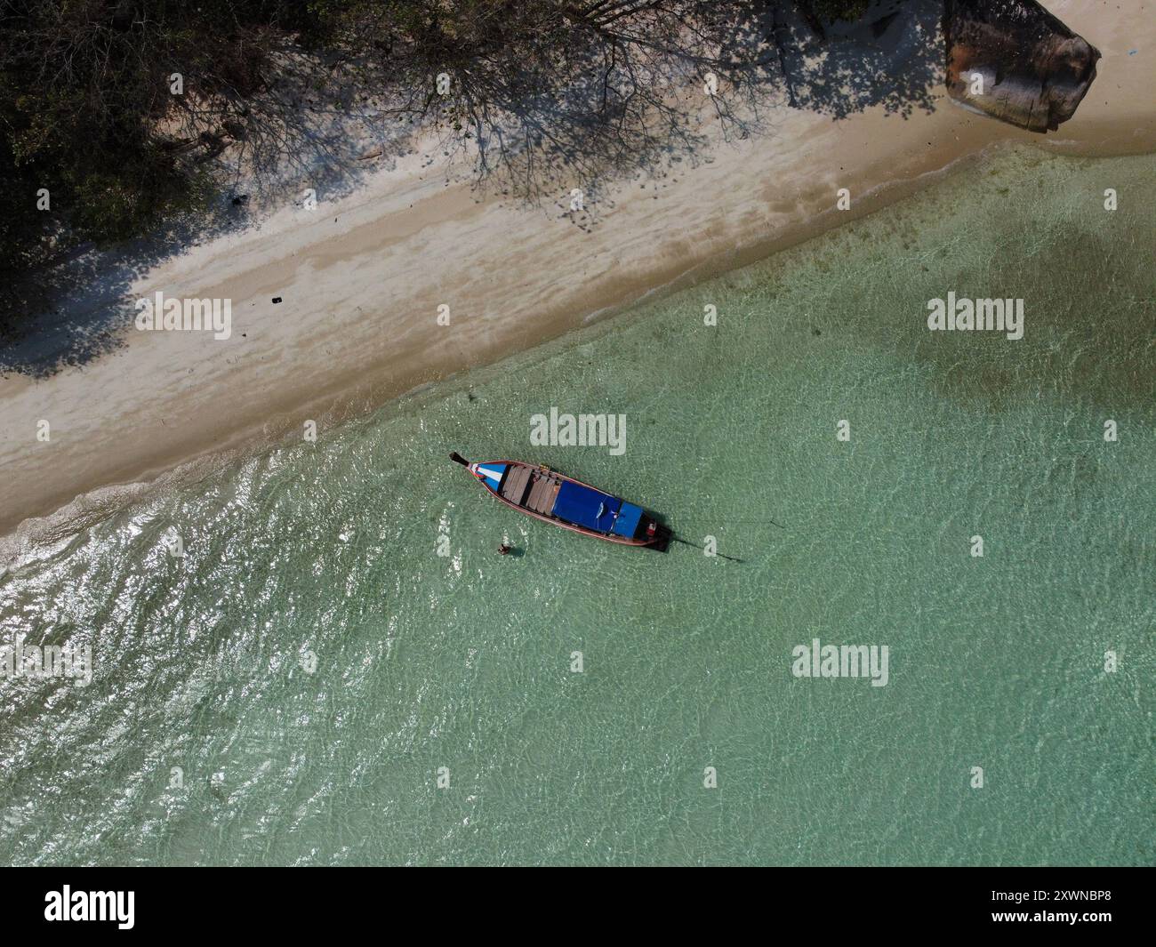 Aerial view of a Ko Ra Wi not touristy beach with a long tail boat in ...