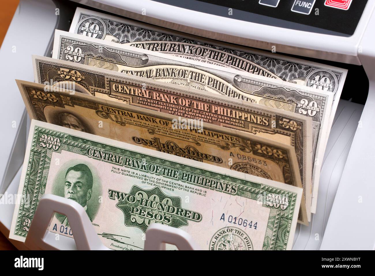 Old Philippine money - peso in the counting machine Stock Photo - Alamy
