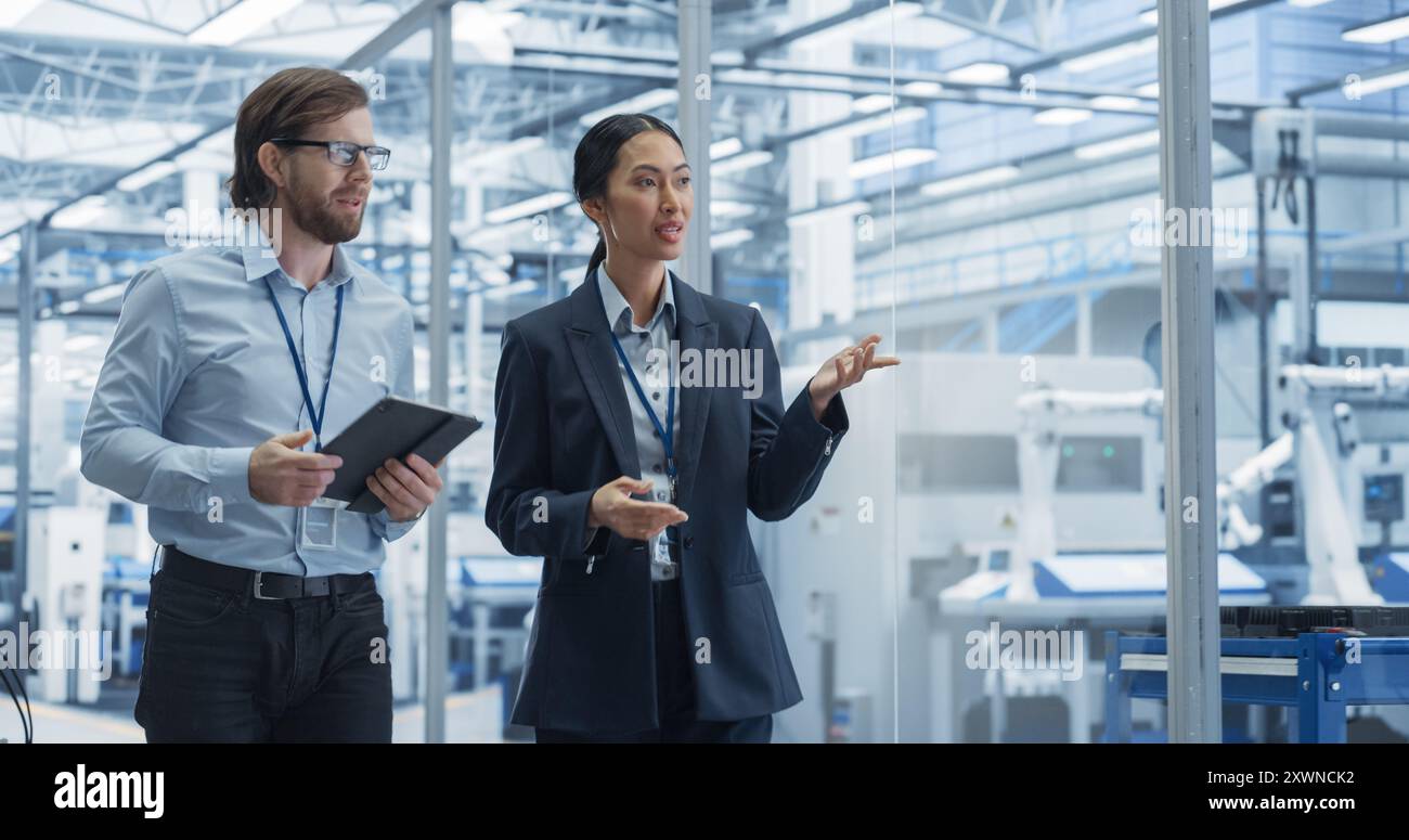 Two Diverse Engineers Walking in Office, Using Tablet Computer at a ...