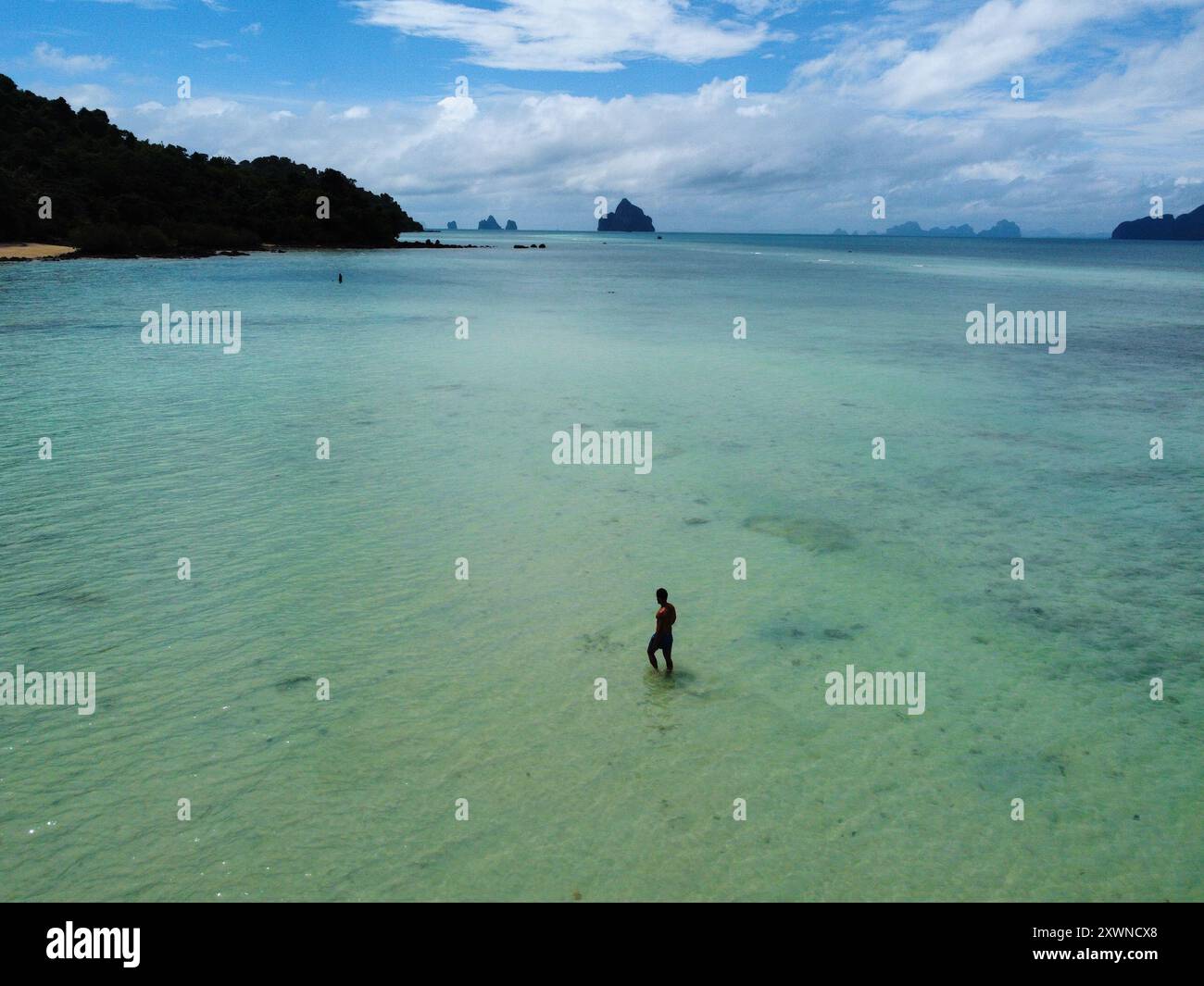 Aerial view of the Koh Kradan beach with a traveler exploring the coral ...