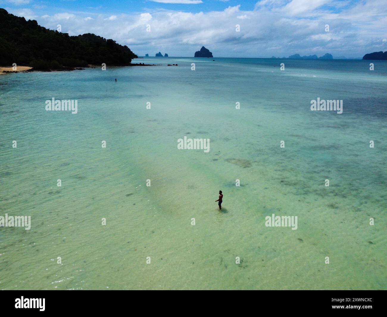 Aerial view of the Koh Kradan beach with a traveler exploring the coral ...