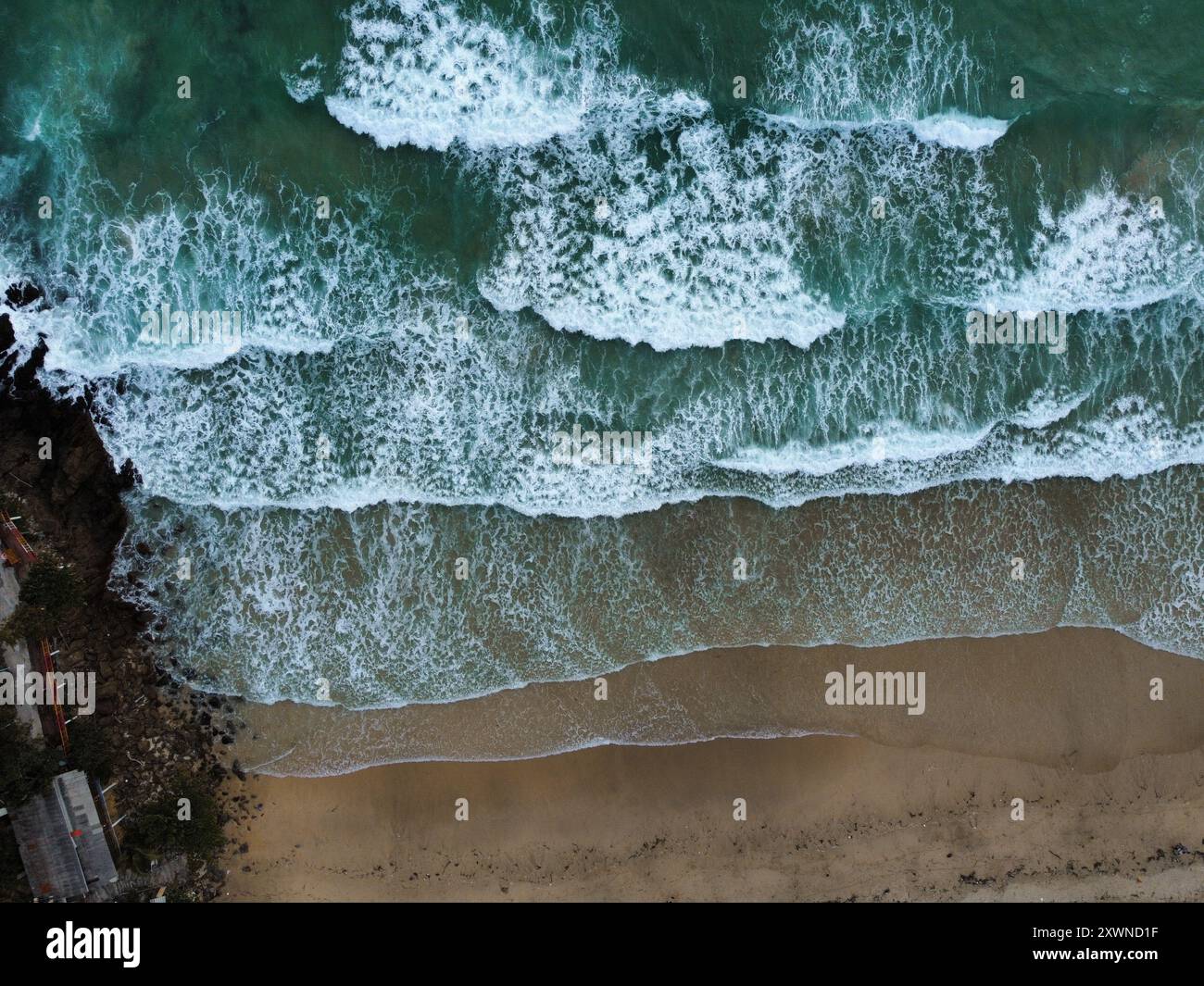 Aerial view of the waves crashing on the Charlie Beach on Koh Mook ...