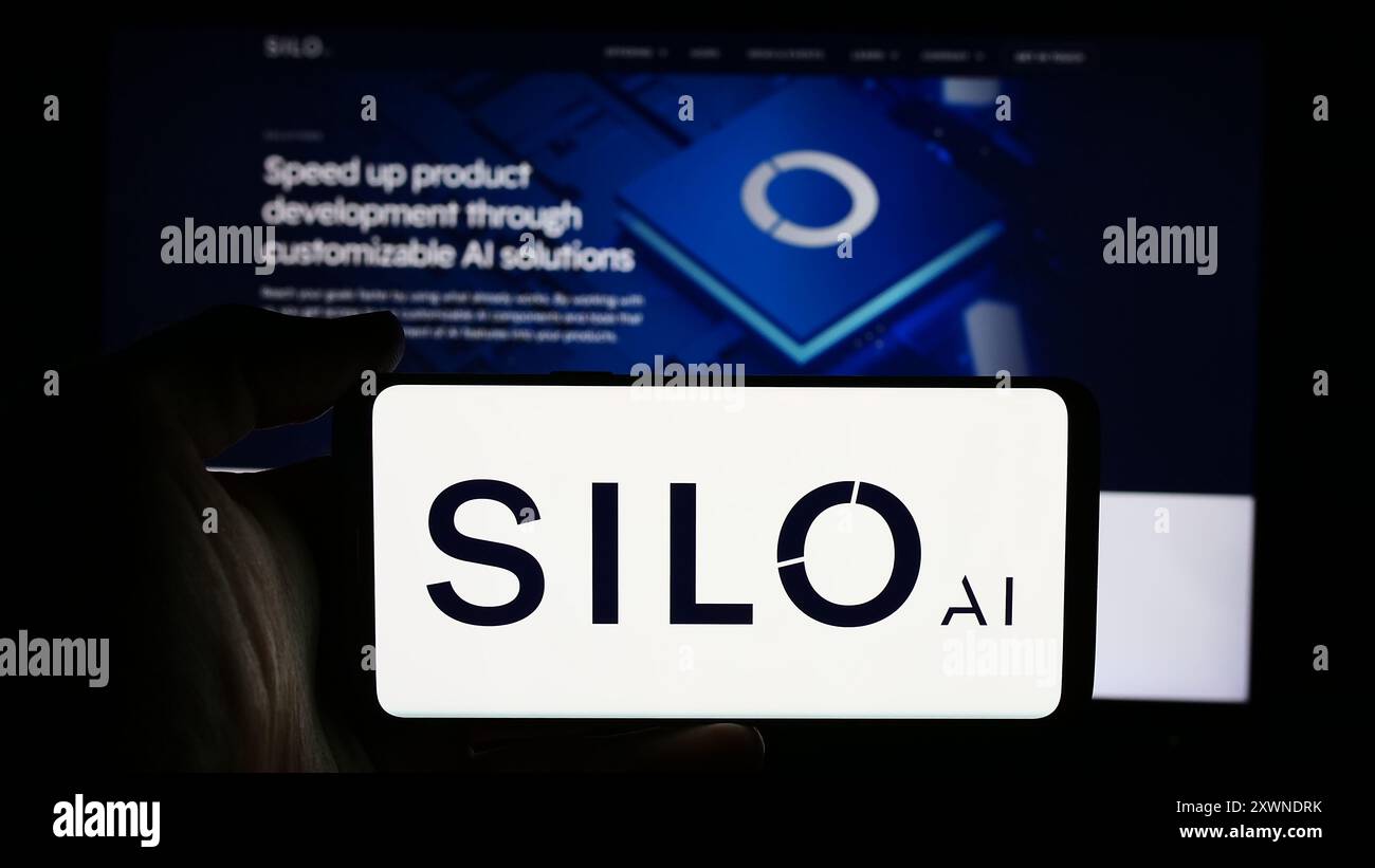 Person holding cellphone with logo of Finnish artificial intelligence ...