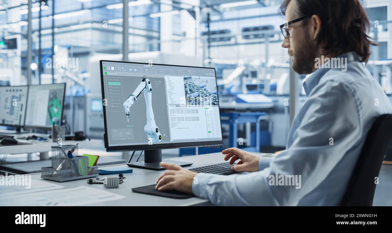System Administrator Working on a Desktop Computer at a Modern ...