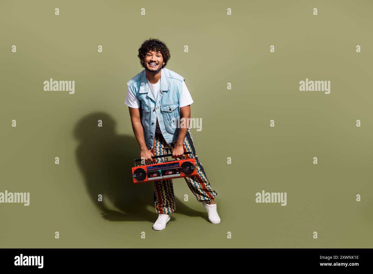 Full size photo of handsome young guy dancing hold boombox wear trendy ...