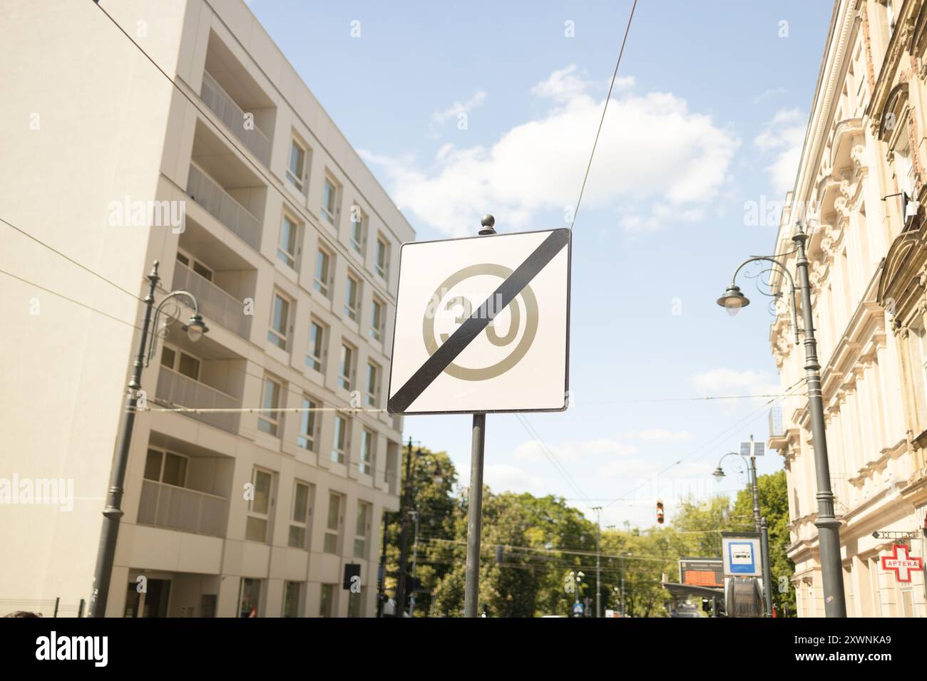 Road signs indicating speed limit and priority road with trees in the ...