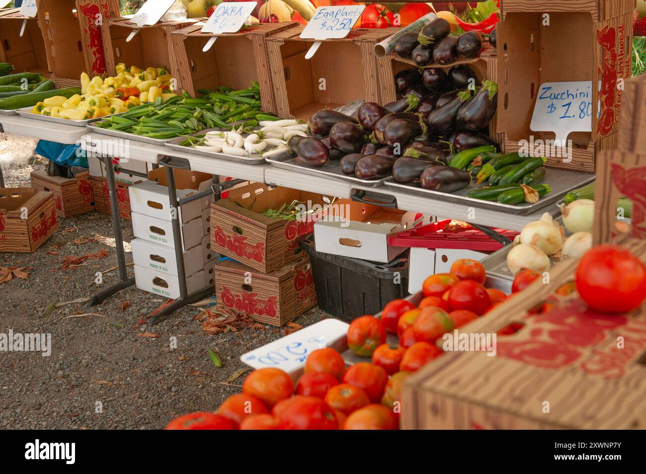 Farmer's market stall with tables covered in a variety of seasonal ...