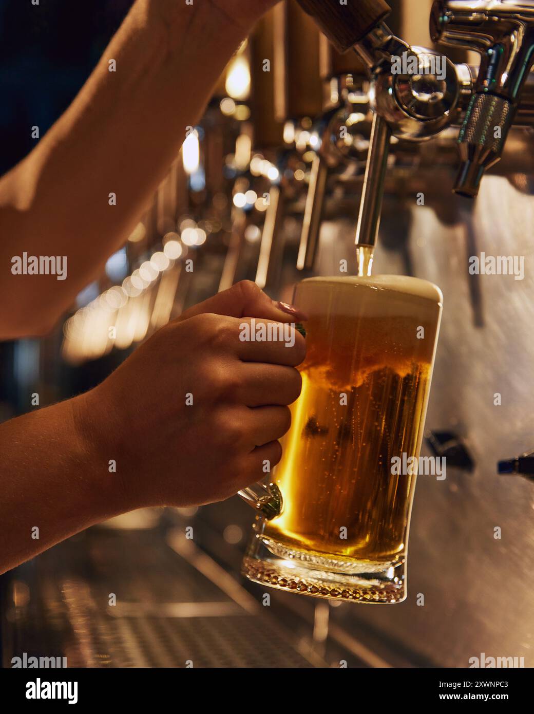 Female bartender pouring lager foamy beer from tap into mug. Modern beer bar, restaurant Stock ...