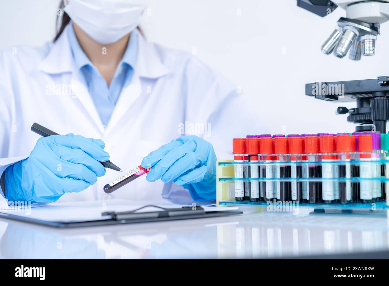 A female scientist is labeling blood samples Stock Photo - Alamy