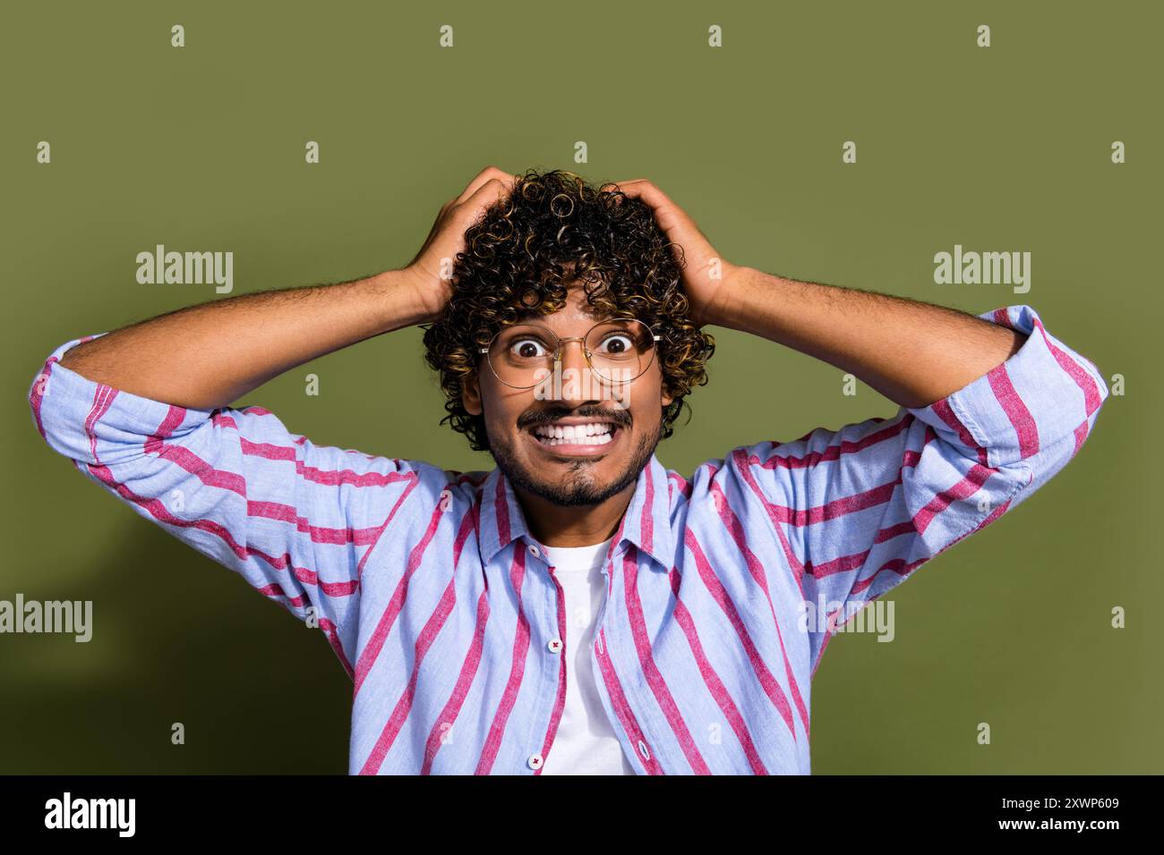 Photo of funky funny crazy guy with wavy hair dressed striped shirt in ...