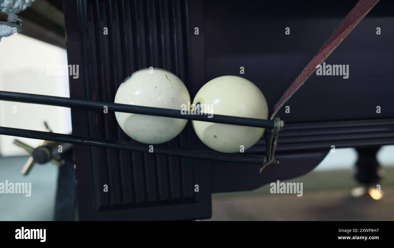 Two white billiard balls in ball return system. Pool table mechanism ...